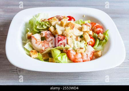 Plate with Caesar salad on white background, closeup Stock Photo - Alamy