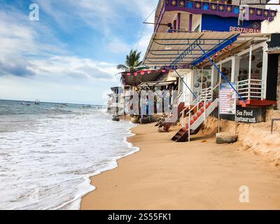 Poor indian house on the ocean beach. Slum poor Stock Photo - Alamy