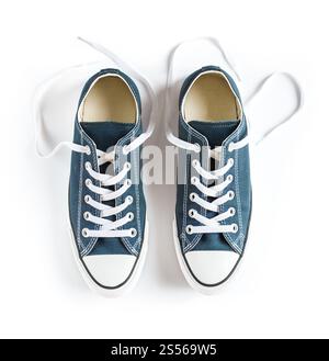 Blue generic sneakers isolated on red background Stock Photo - Alamy
