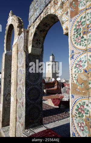 The carpet market in front of the old adobe wall of historic house in ...