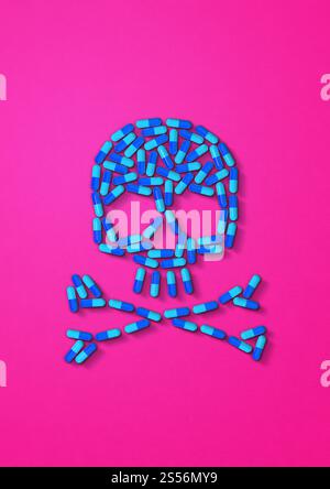 Skull made of blue capsule pills isolated on orange background. 3D ...