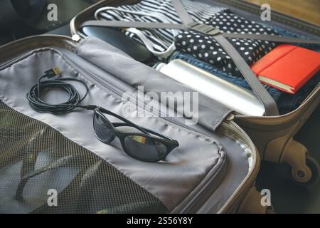 Open vintage travel suitcase full of clothes Stock Photo - Alamy