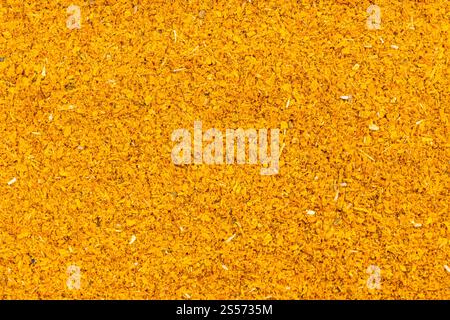 ground dried tagetes (imeretian saffron) in wooden spoon isolated on ...