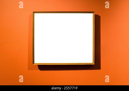 narrow wooden picture frame with cutout canvas on orange wall Stock ...