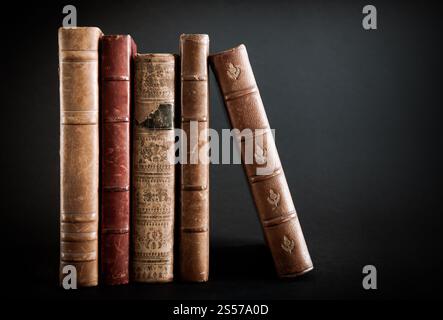 Row of old books on black shelf. Horizontal background scene Stock ...