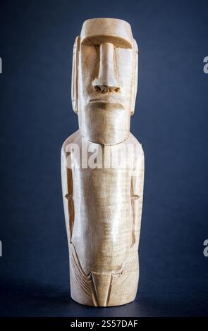 Traditional wooden statue of a moai from Easter Island. Dark background ...