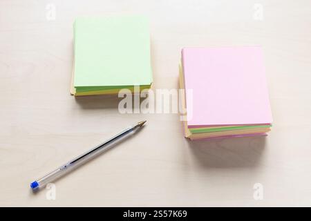 top view of stacks of blank colorful sheets of note paper on light ...