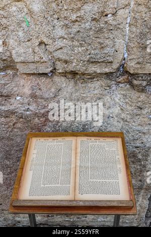 A Talmud open to the text from the tractate Ketubot rests on a prayer ...