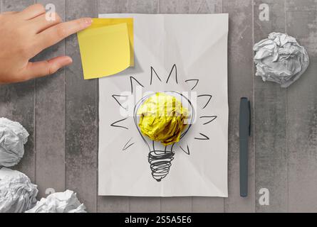 sticky note with another idea light bulb on crumpled paper as creative ...