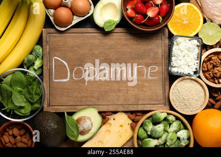 Wooden board with word Dopamine and different products as background ...
