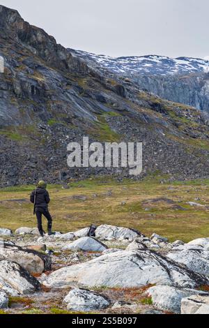 Female tour leader with a rifle keeping a look out to protect tourists ...