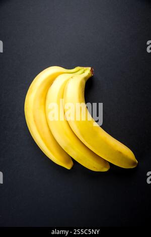 Yellow bananas on a black background Stock Photo - Alamy