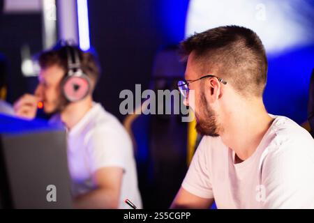 Joyful gamer emotionally plays tight arcade racing, facial expressions ...