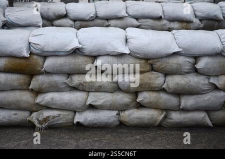 Background of many dirty sand bags for flood defense. Protective ...