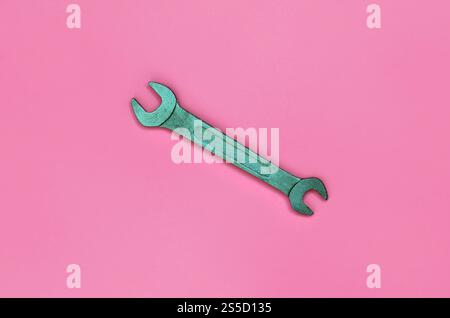 Metallic spanner lie on texture background of fashion pastel pink color ...