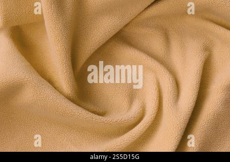 The blanket of furry orange fleece fabric. A background of light orange ...