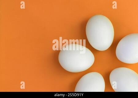 A few white easter eggs on a bright orange background Stock Photo - Alamy