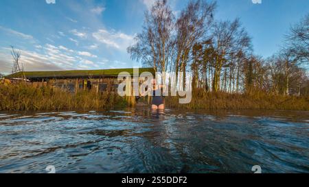Lone female wild swimmer steps into the waters of the deserted Monet ...