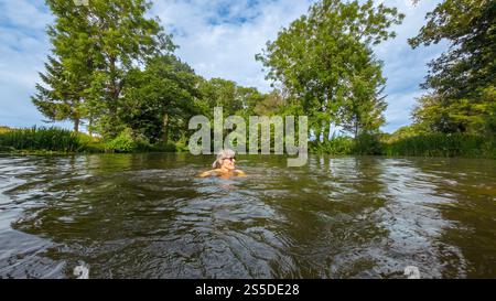 Female wild swimmer at Chaloner Pond. York Stock Photo - Alamy