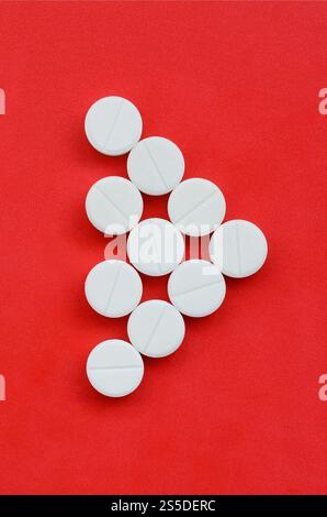 Arrow of Pills on red background Stock Photo - Alamy