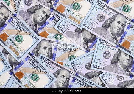 A large number of US dollar bills of a new design with a blue stripe in ...