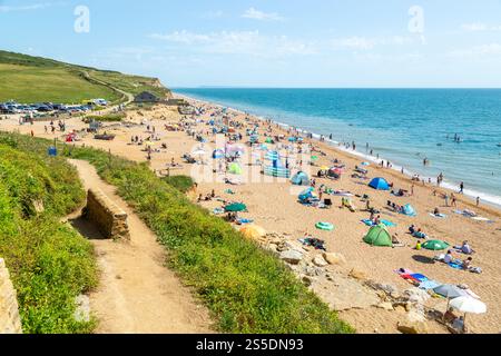 Crowds of tourists enjoying the beach at Burton Bradstock, Dorset ...