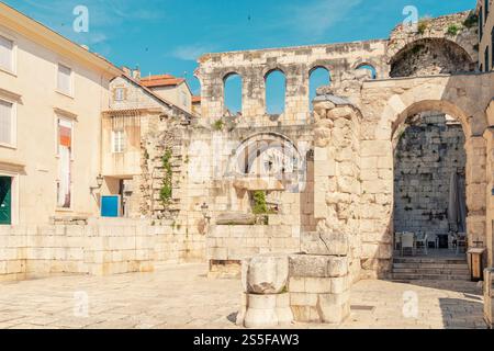 Ancient stone ruins with arches under a blue sky, a blend of history ...