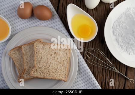 Eggs, bread, tapioca flour and an egg beater, ingredients used in ...