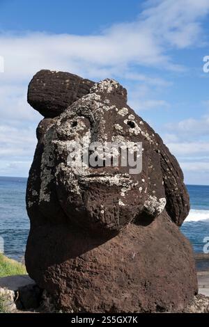 Modern stone statues stand alongside the road into Hanga Roa, Easter ...
