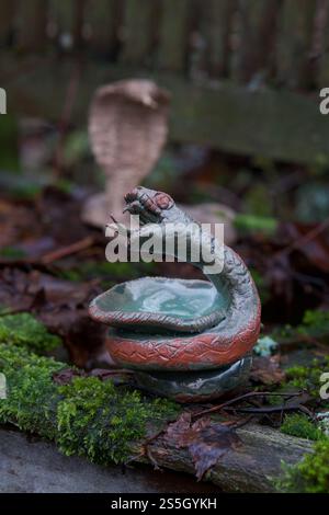 Clay snake on a mossy background Stock Photo - Alamy