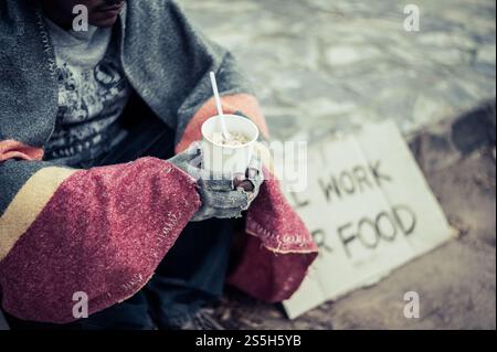 The beggars sat wrapped in cloths and eating noodles Stock Photo - Alamy