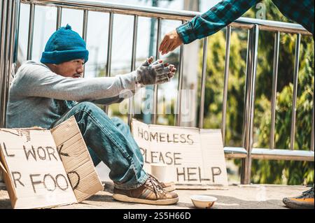 The man sitting begging on an overpass with messages homeless people ...