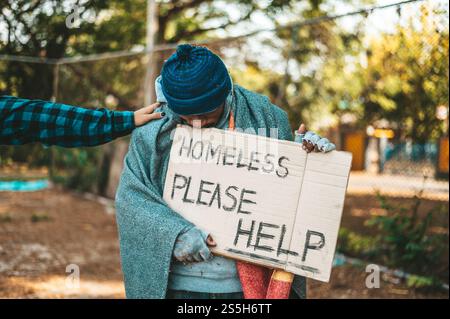 Beggar stand on the street with homeless messages please help Stock ...