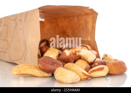 Brazil nuts without shells with paper bag, close-up, isolated on white ...
