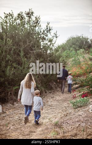 Four kids spending time together. Outdoor picnic blanket, sitting with ...
