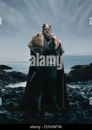 Standing medieval king holding his golden sword Stock Photo - Alamy