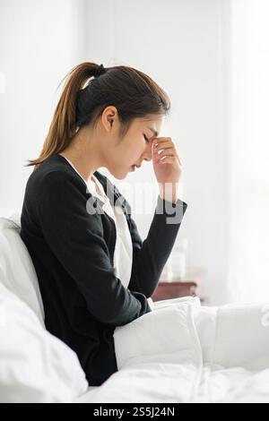 A sick woman with a headache and put her hand on her head Stock Photo ...