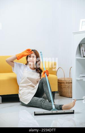 Tired young woman after cleaning in kitchen Stock Photo - Alamy