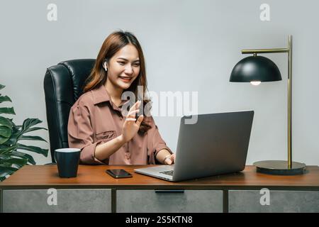 New normal businesswoman work from home by laptop sitting on the sofa ...