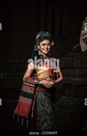 Pretty charming young Asian female university student doing homework ...