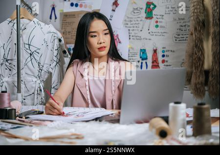 Portrait woman dressmaker drawing paper sew pattern textile clothes ...