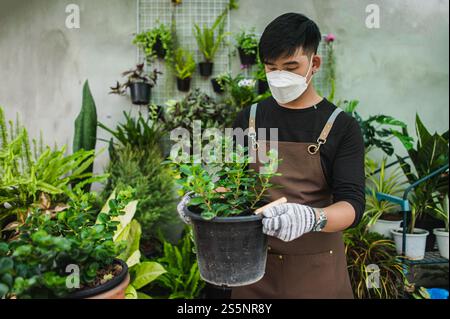 Man in face mask in gardening tools store Stock Photo - Alamy