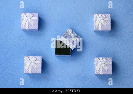 Open gift box with blue ribbon and bow blue background Stock Photo - Alamy