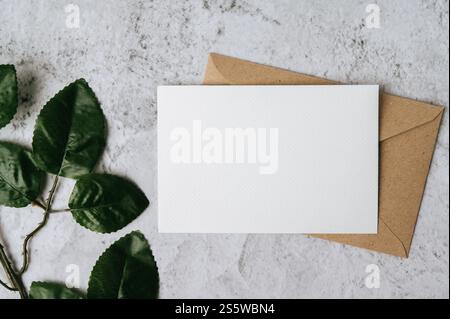 A blank card with envelope and leaf is placed on white background Stock ...