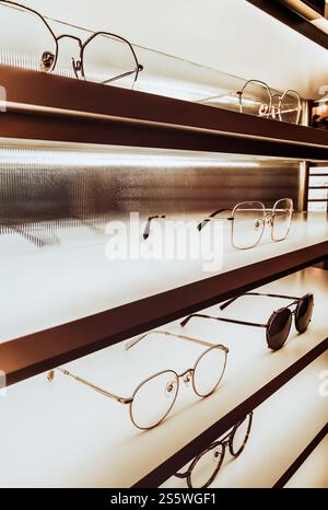 Eyeglasses selection displayed on optical store shelf Stock Photo - Alamy
