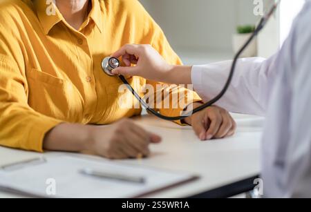 Doctor checking heart beat of patient in bed with stethoscope Stock ...