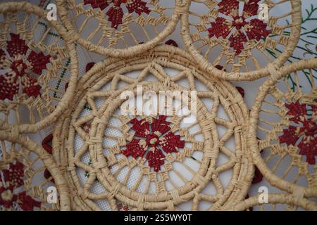 Cretan basket traditionally woven with patterns of red flowers with ...