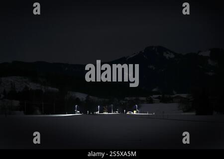 Seeg, Germany. 15th Jan, 2025. A car drives through a traffic circle in ...