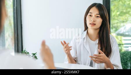 Female Asian blogger with laptop on orange background Stock Photo - Alamy