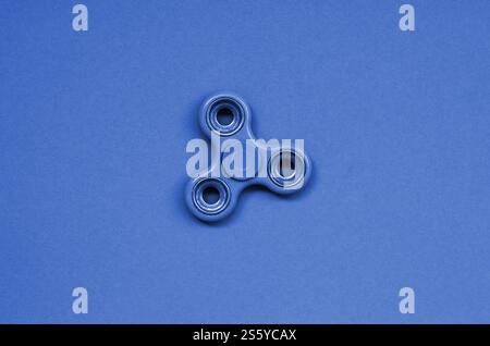 Green fidget spinner lies on texture background of fashion pastel green ...